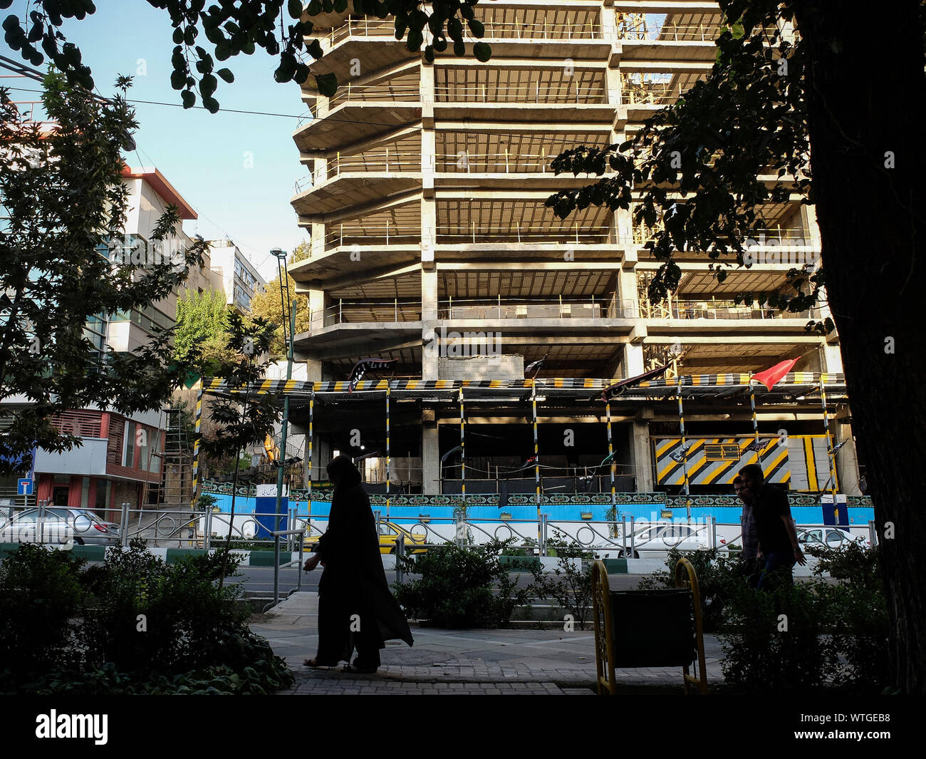 Tehran, Iran. 12th Sep, 2019. A veiled woman walks past an under ...
