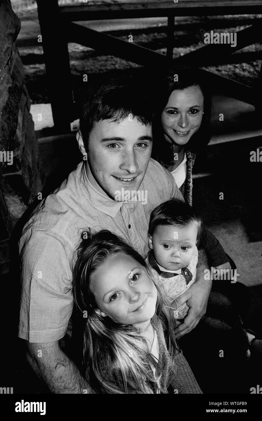 Sitting holding smiling childhood looking at camera bonding innocence ...