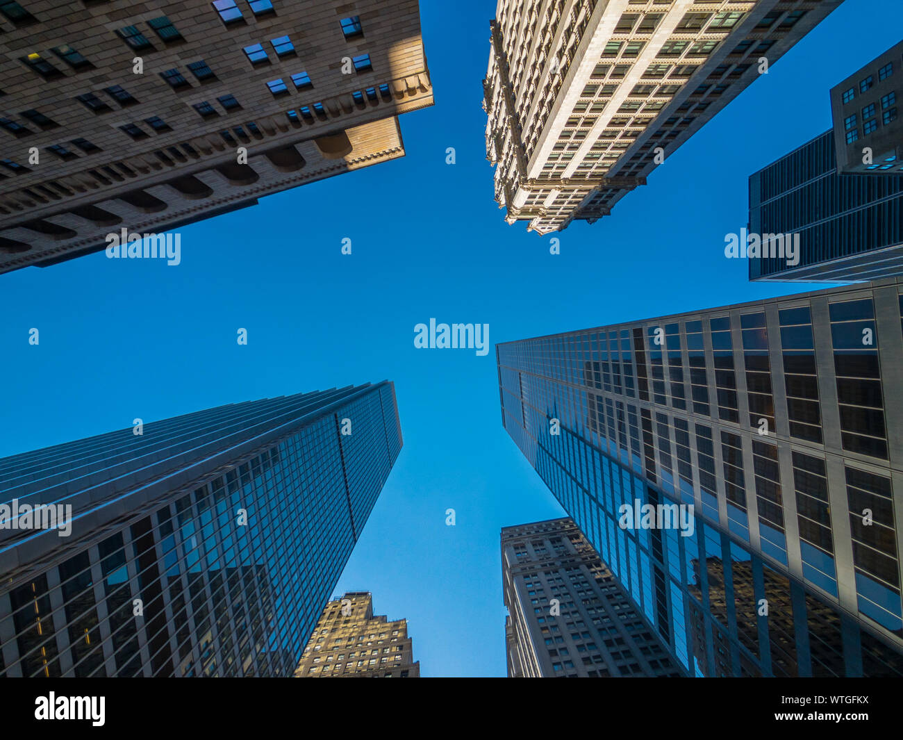New York skyscrapers bottom view blue sky Stock Photo - Alamy