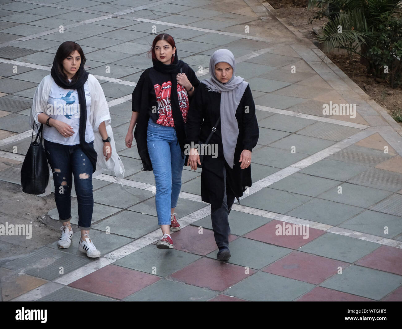 Tehran, Iran. 12th Sep, 2019. People walk on a sidewalk on Valiasr ...