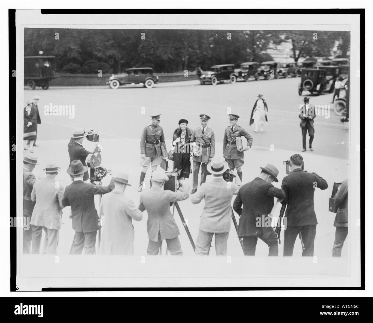 Mitchell, his wife, and aides being photographed before going into the ...