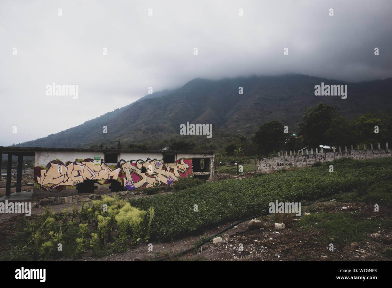 Graffiti on Building in Front of Cloud Covered Volcano in San Pedro la ...