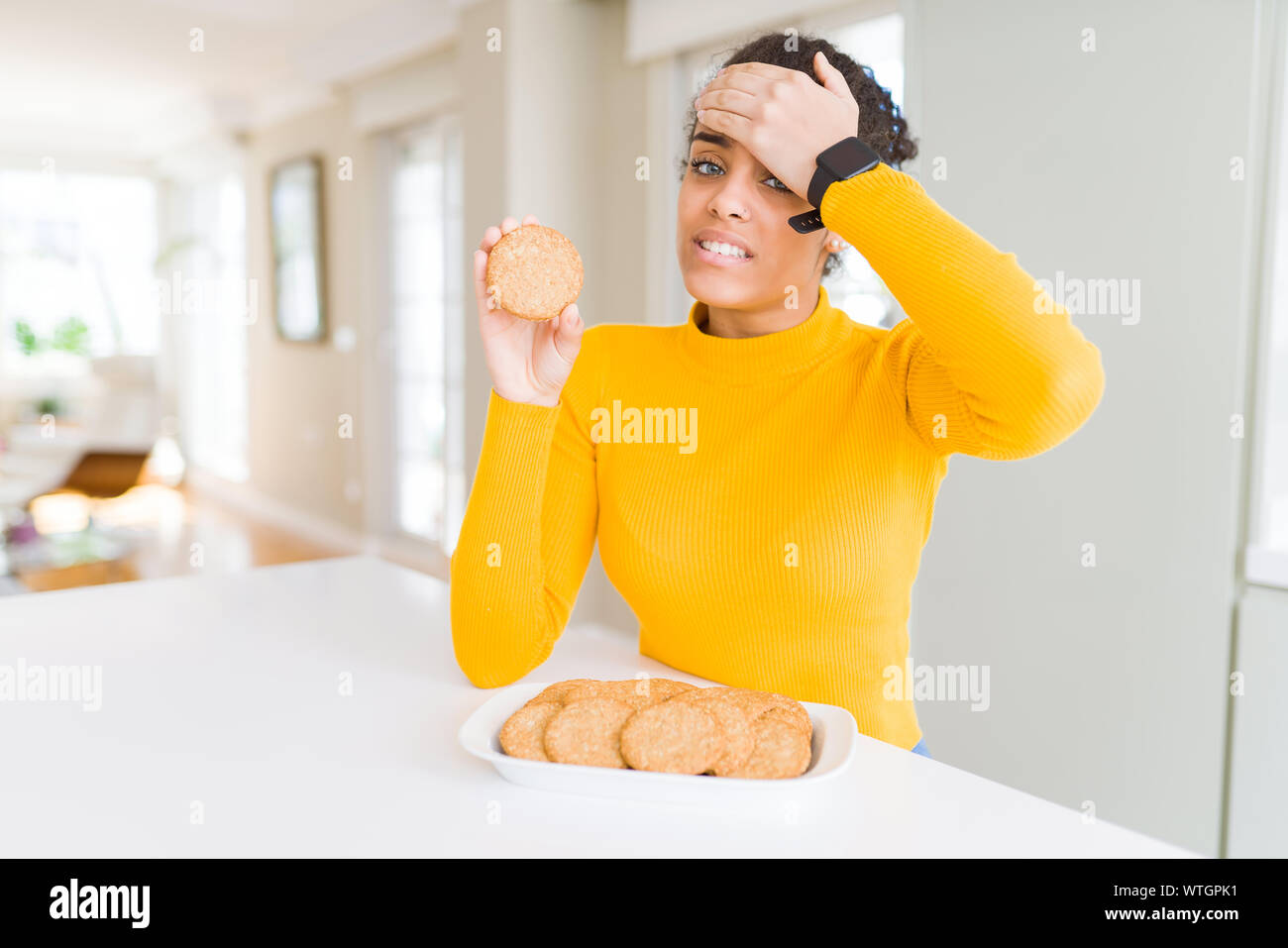 Young african american girl eating healthy whole grain biscuits ...