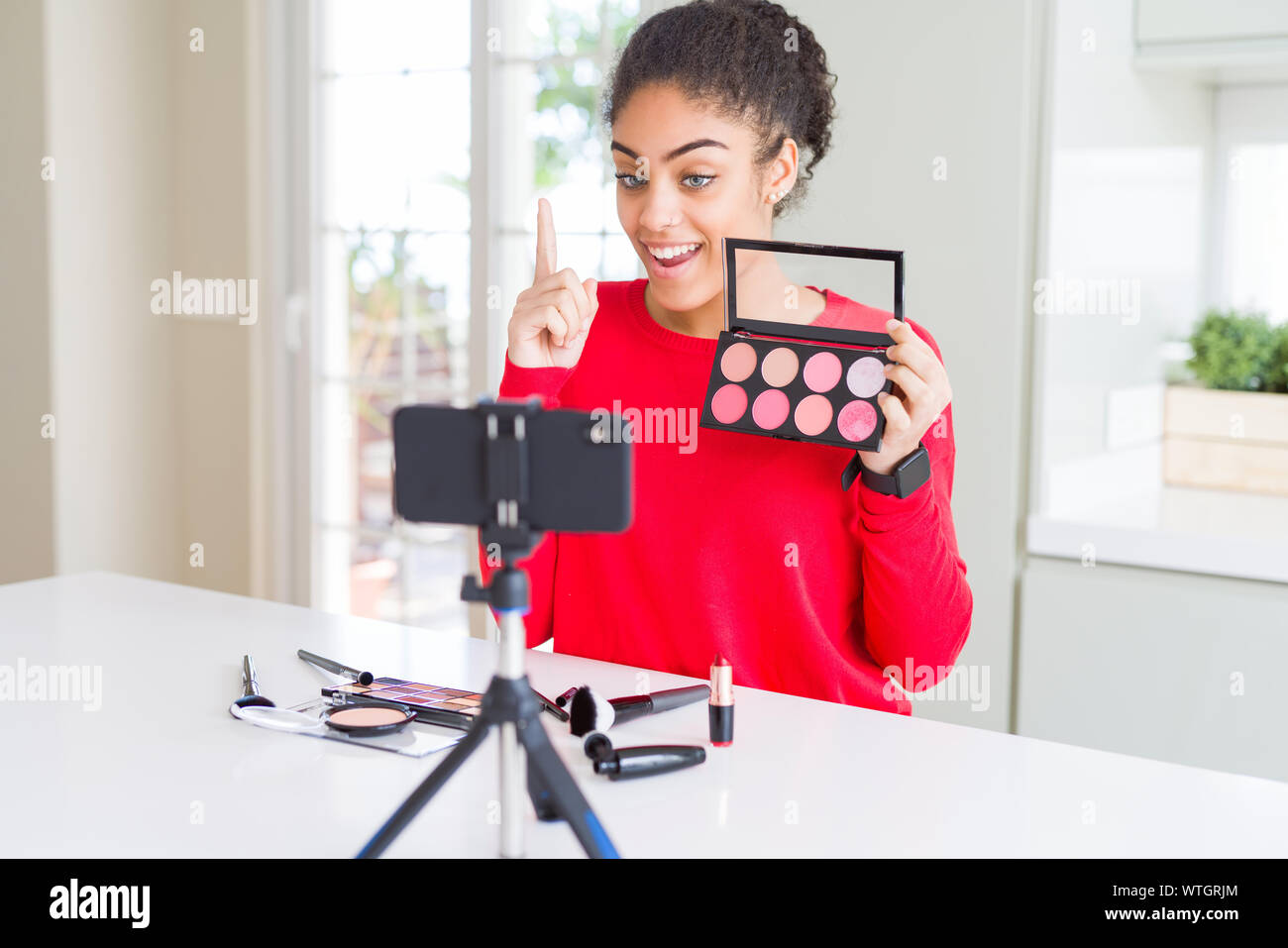 Young african american influencer woman recording make up tutorial ...