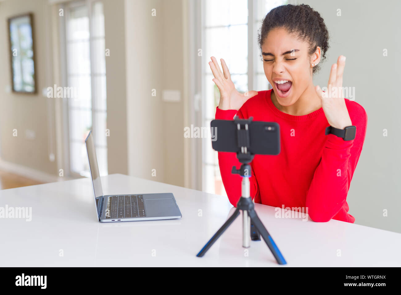 Young african american woman doing video call using smartphone camera ...