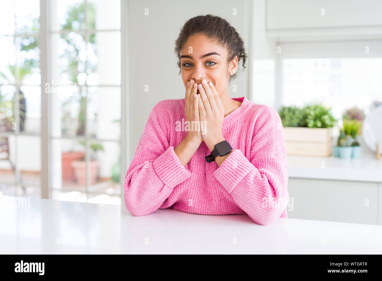 Beautiful african american woman with afro hair wearing casual pink ...