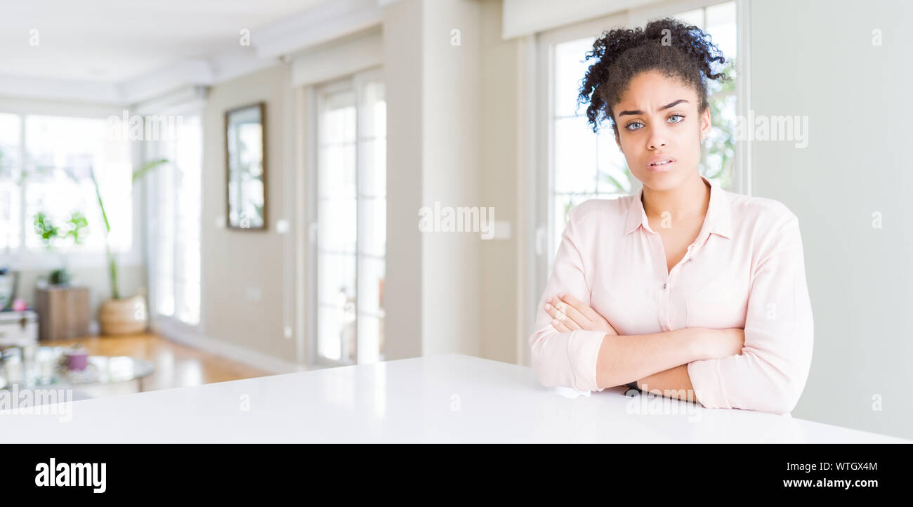Wide angle of beautiful african american woman with afro hair skeptic ...