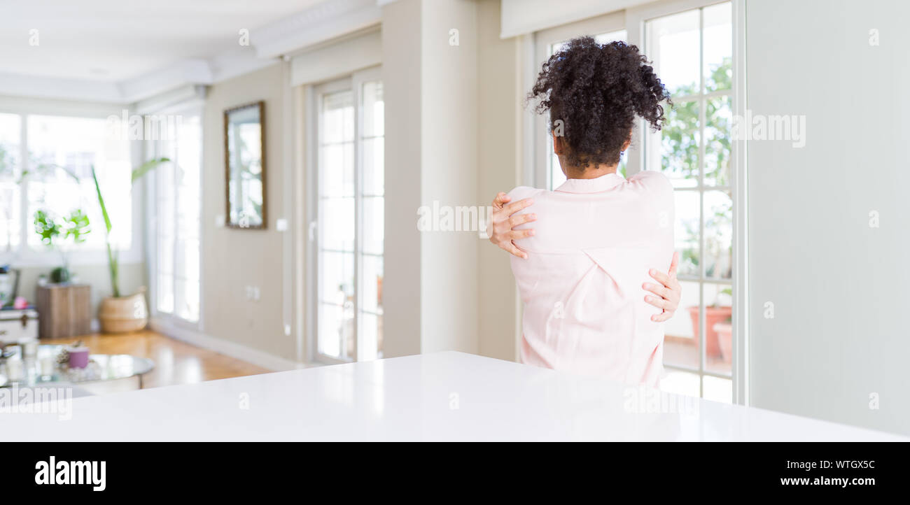 Wide angle of beautiful african american woman with afro hair Hugging ...