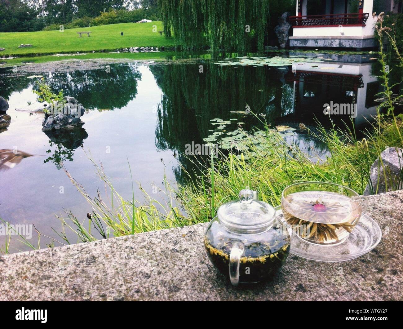 Chinese Tea Containers On Retaining Wall By Pond Stock Photo - Alamy