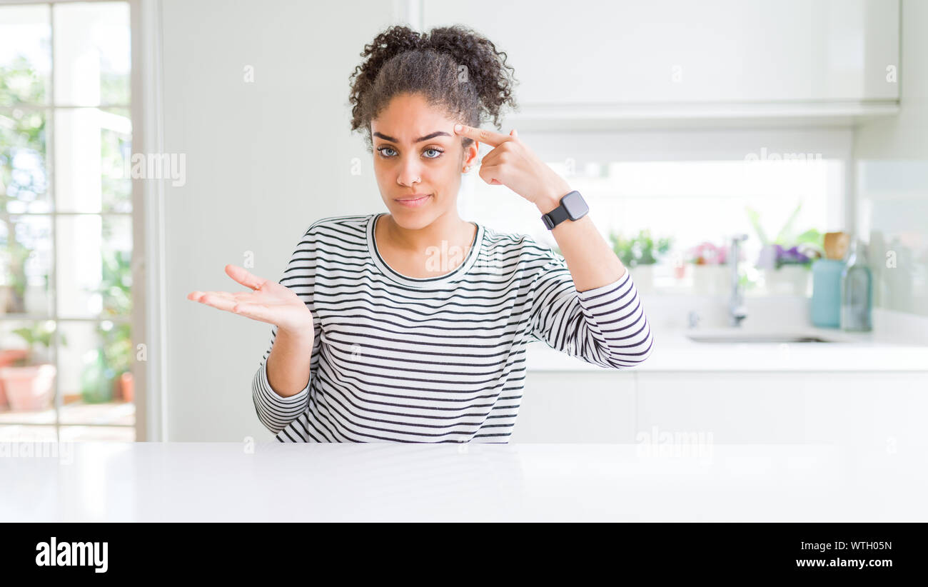 Beautiful african american woman with afro hair wearing casual striped ...