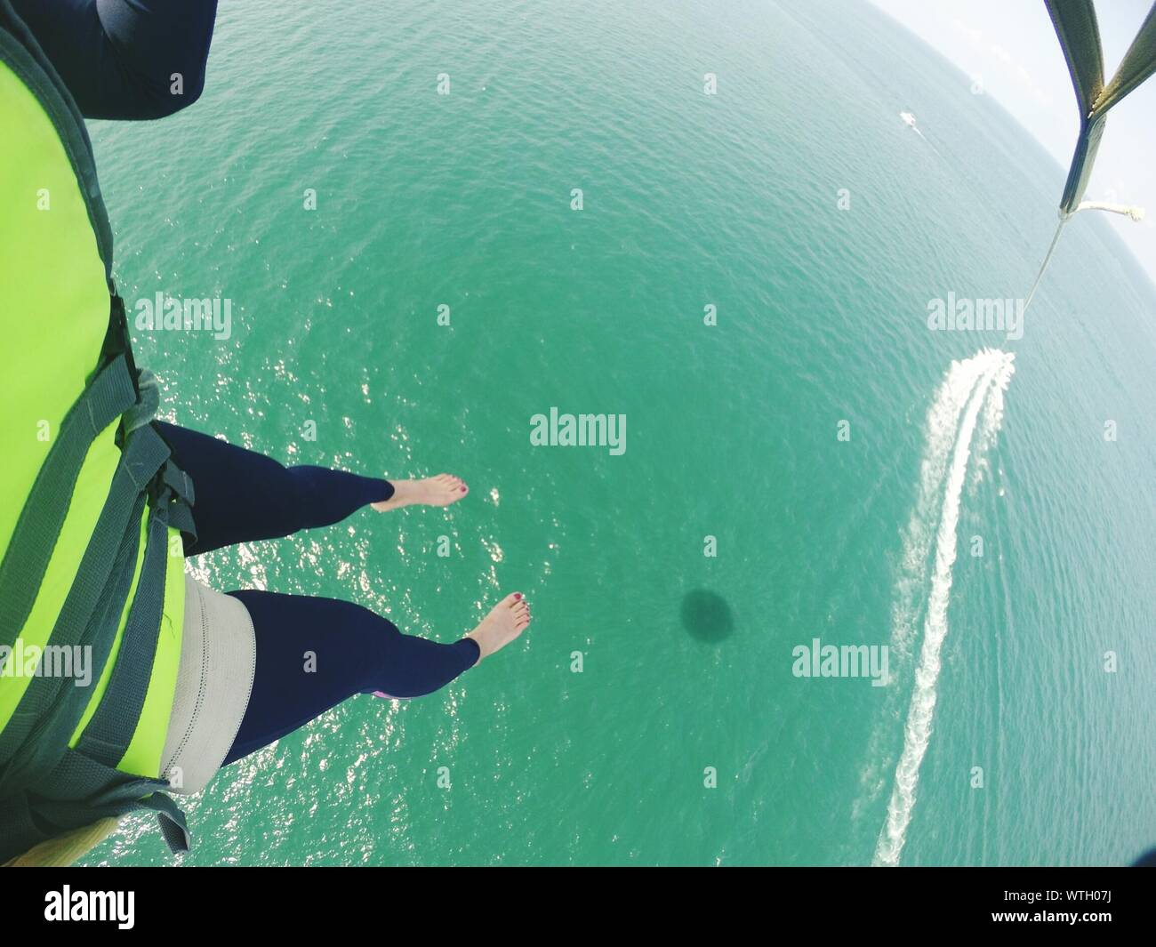 Low Section Of Woman Hanging Over Sea Stock Photo - Alamy