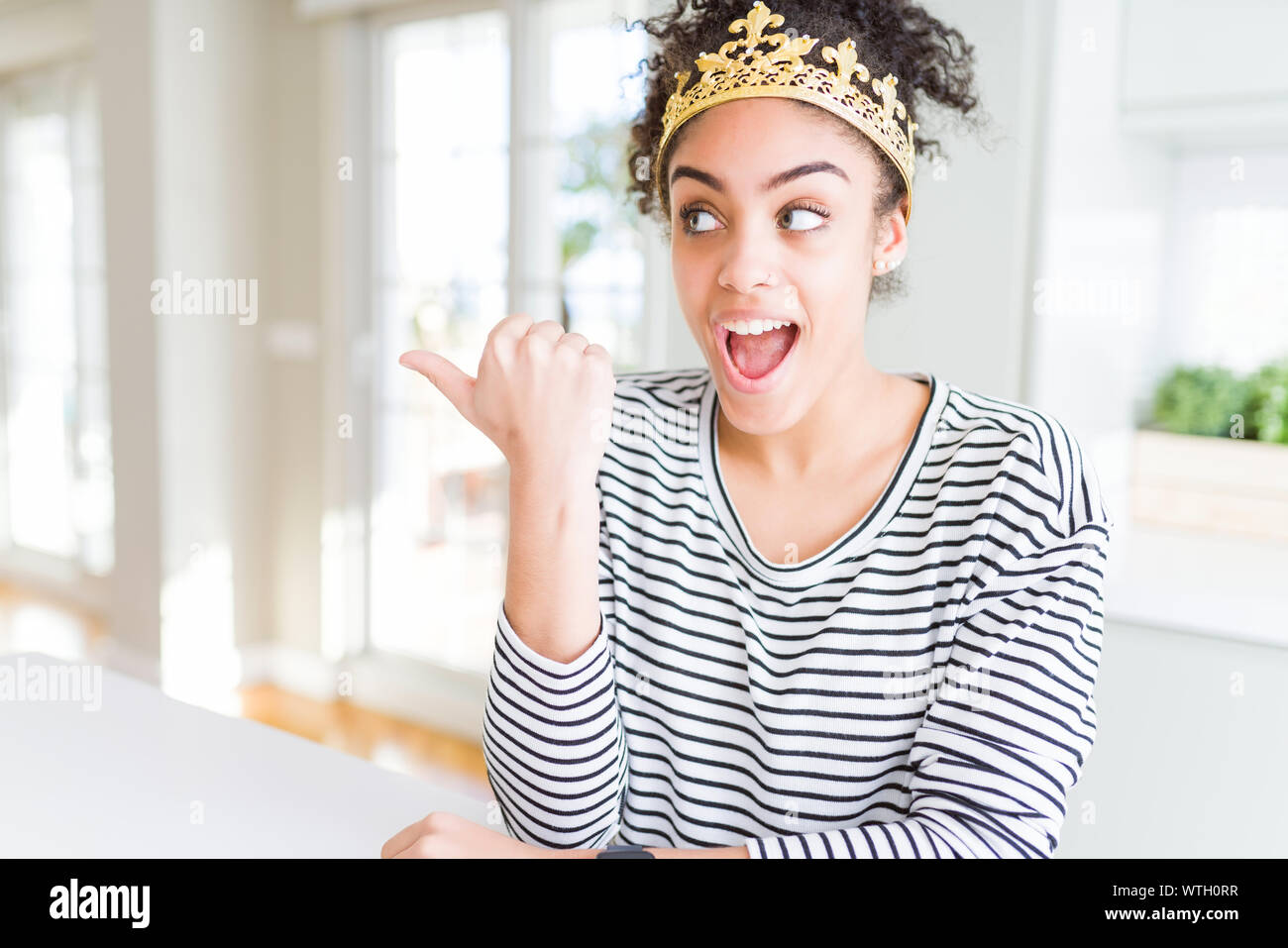 Young african american girl wearing golden queen crown on head smiling ...