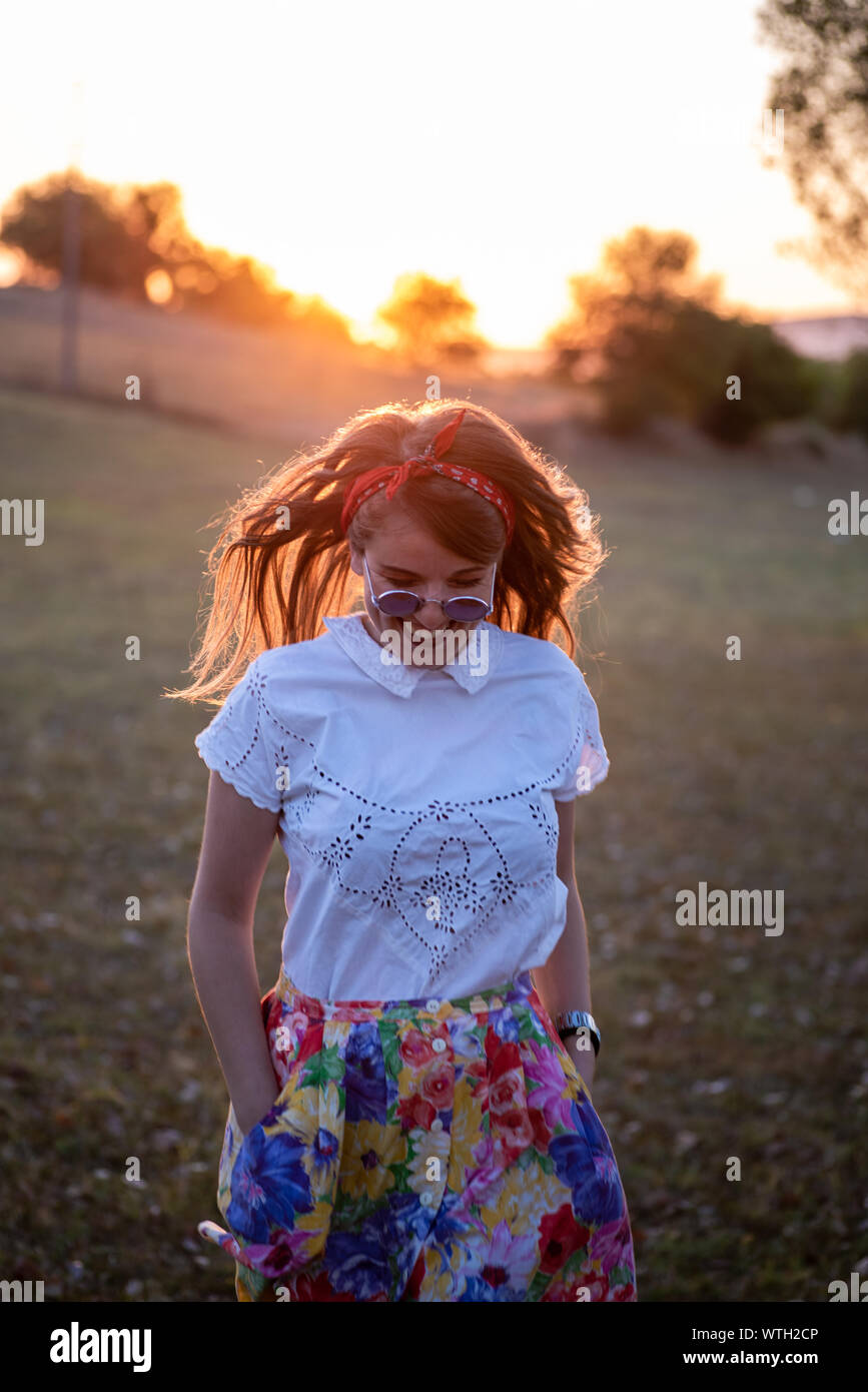 Fashionable girl running through the field at sunset Stock Photo - Alamy