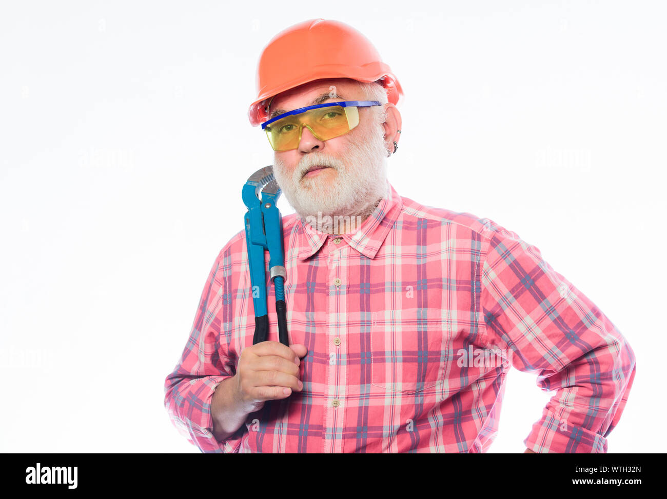 Plumber service. Man bearded plumber wear helmet and hold wrench tool ...