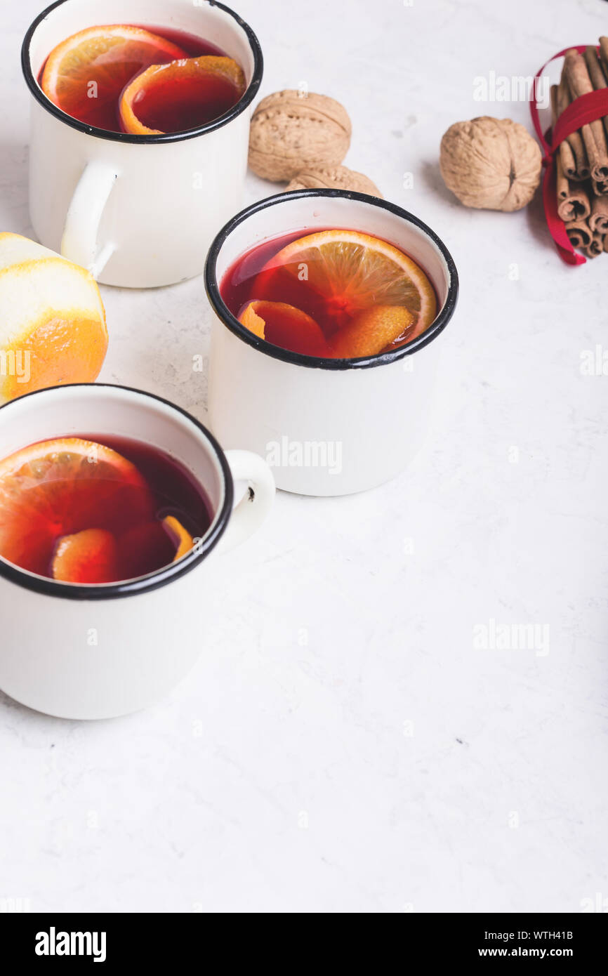 Hot drinks mulled wine, fresh orange fruits. Christmas party or ...