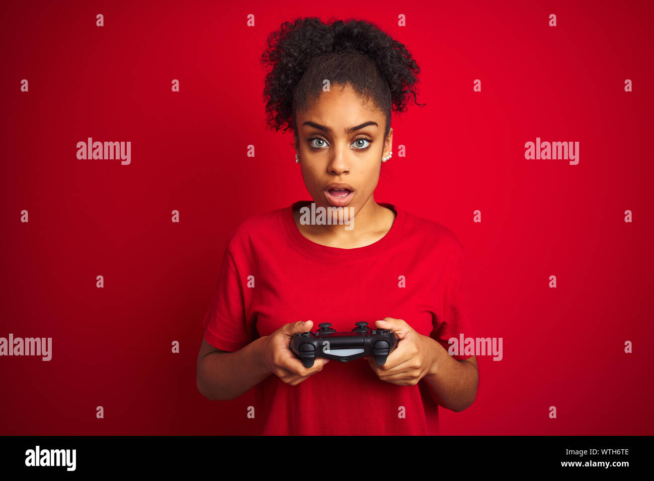 African american gamer woman playing video game using joystick over ...