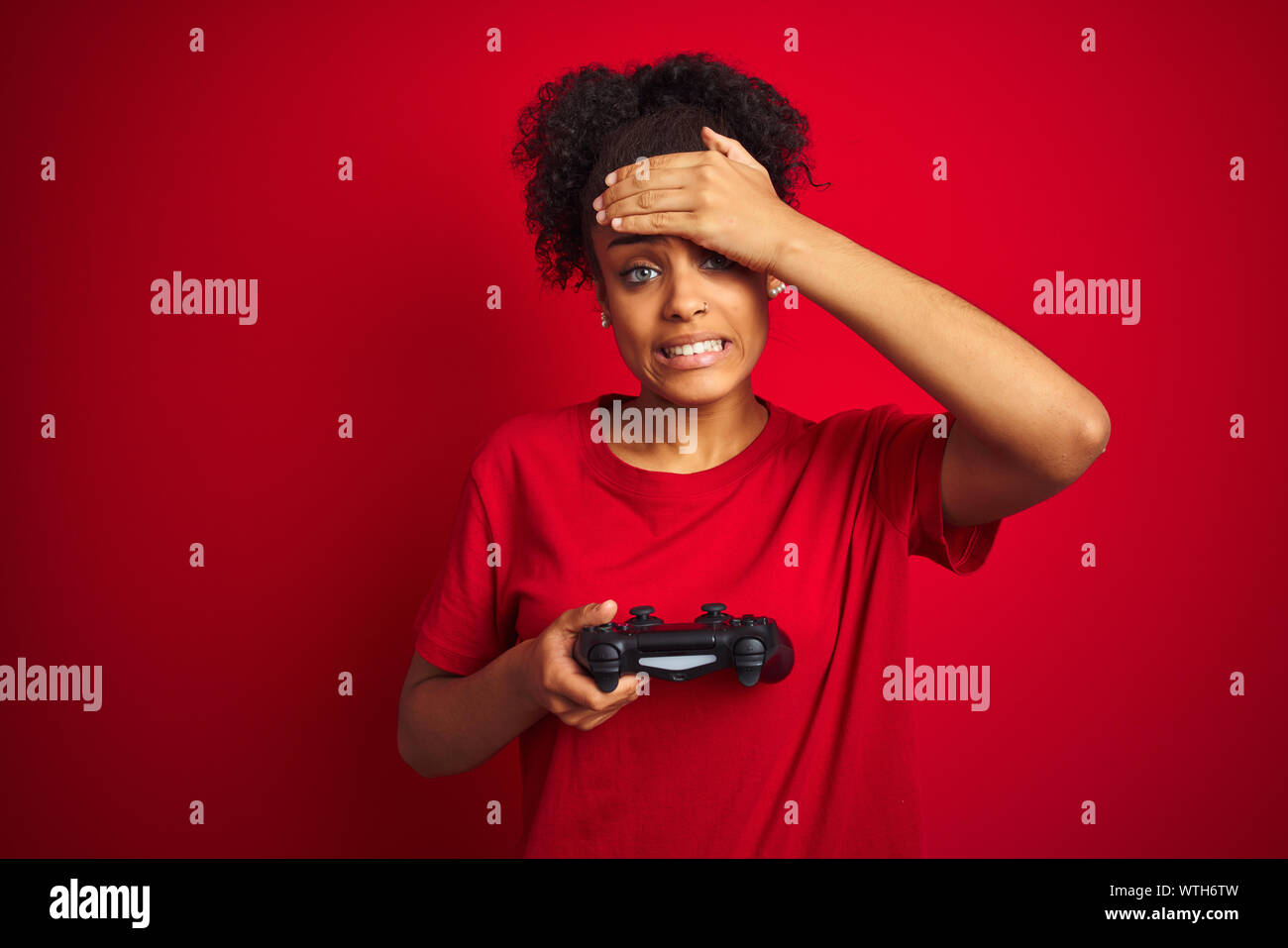 African american gamer woman playing video game using joystick over ...