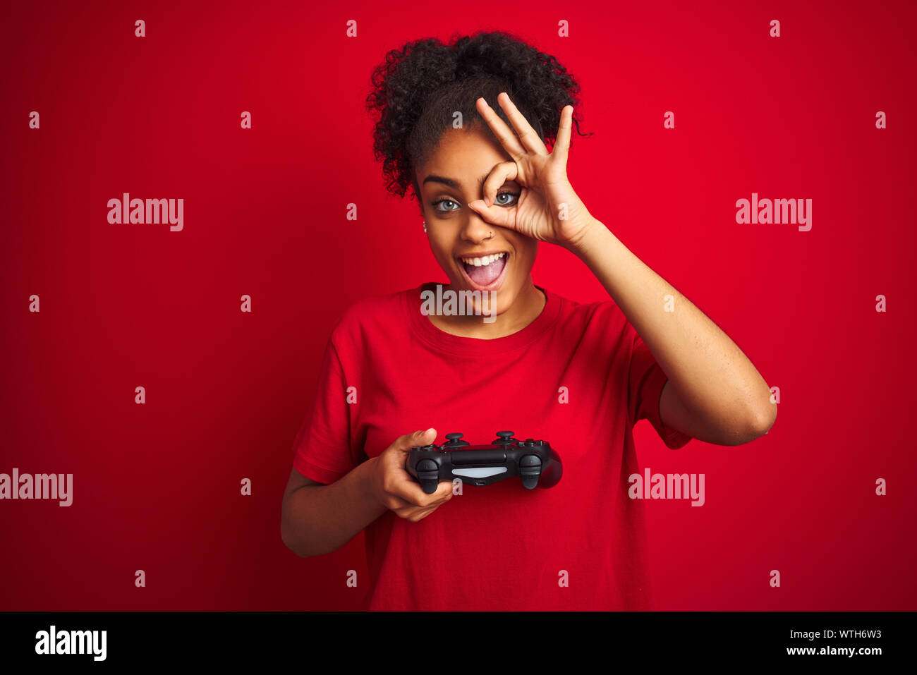 African american gamer woman playing video game using joystick over ...