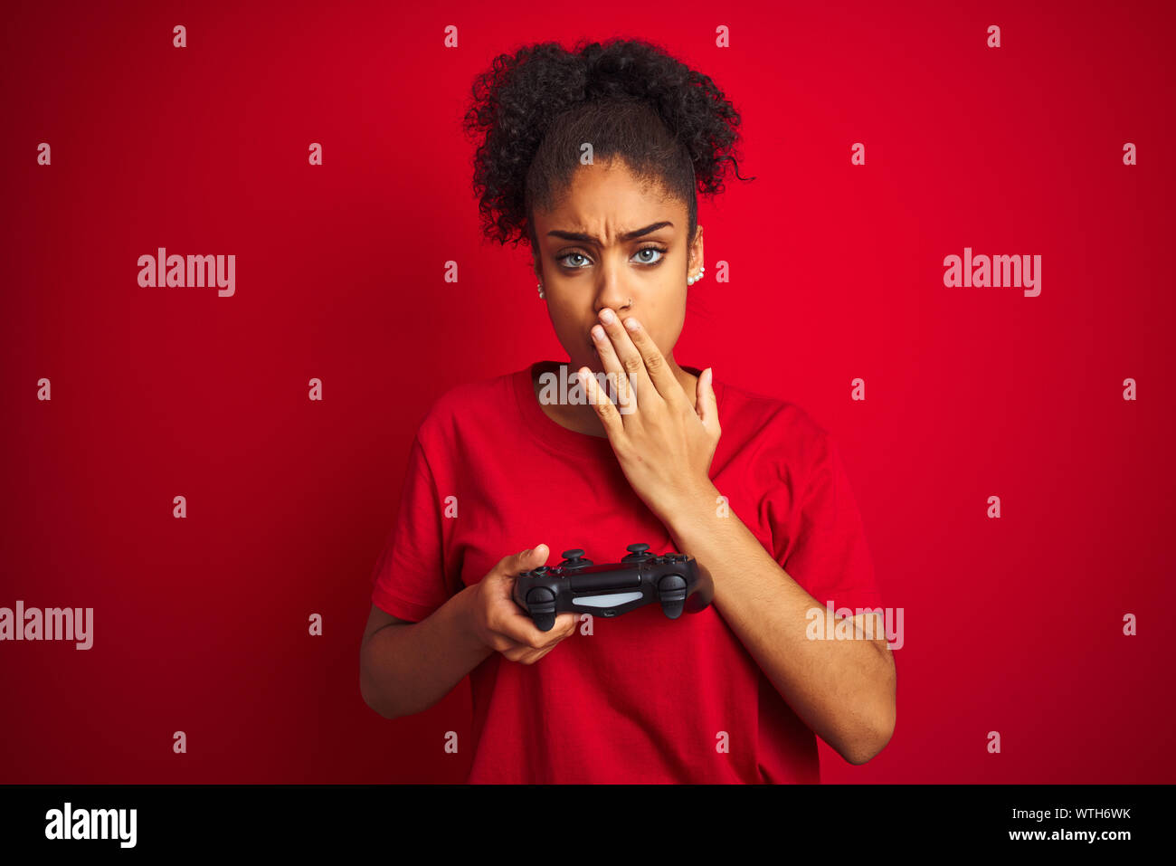 African american gamer woman playing video game using joystick over ...