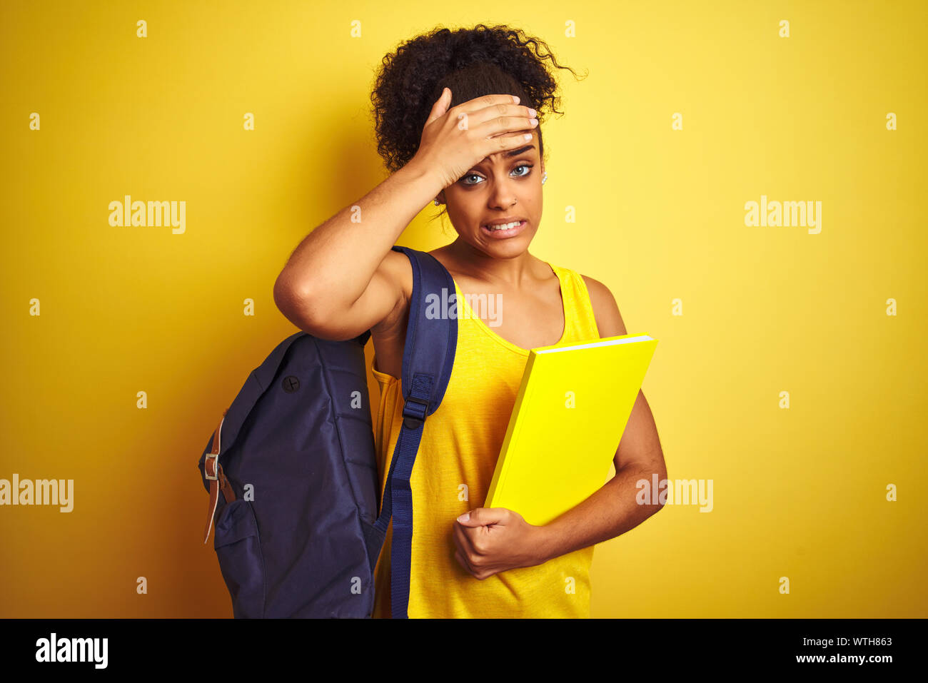 American student woman wearing backpack holding notebook over isolated ...