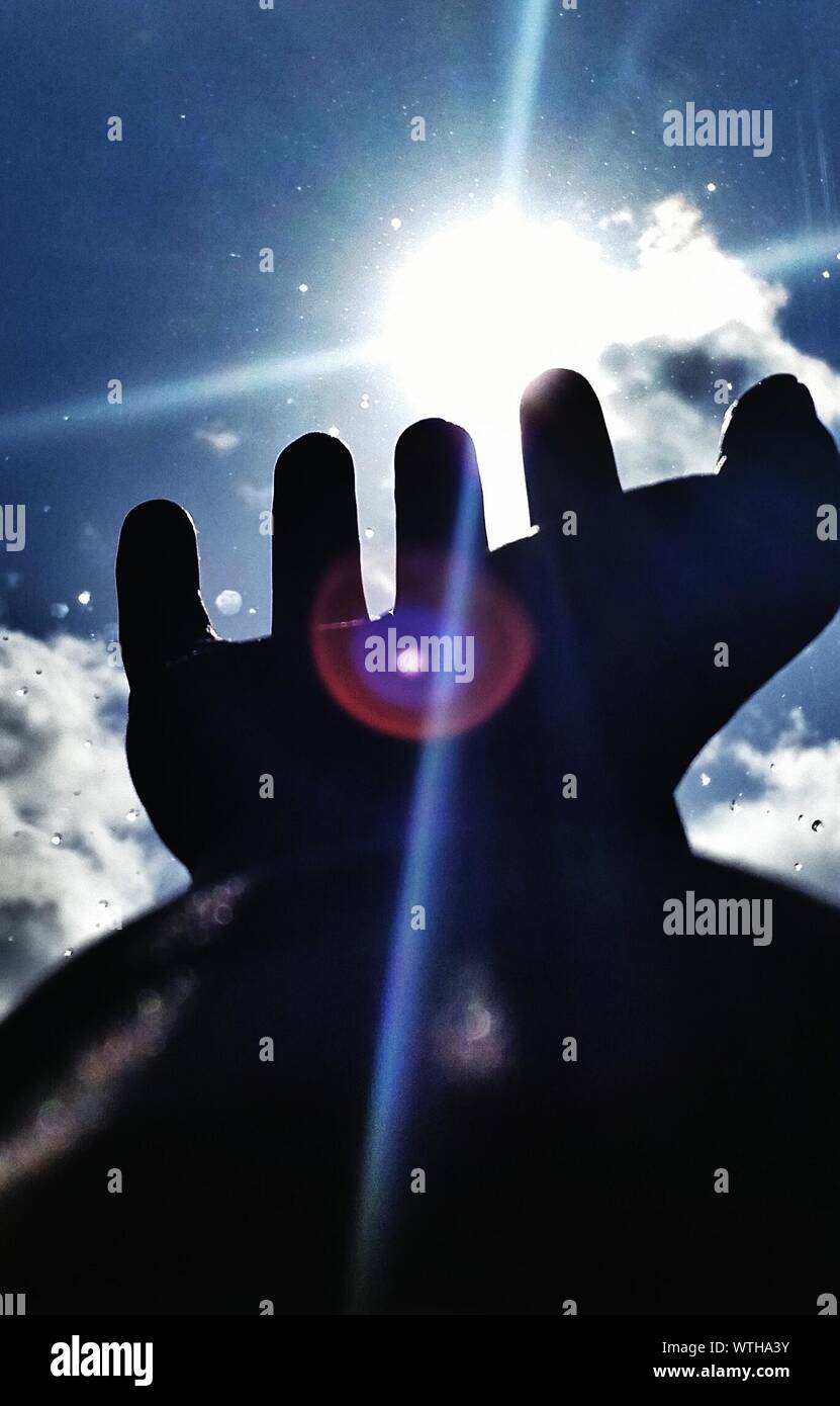 Hand reaching towards sunlight hi-res stock photography and images - Alamy