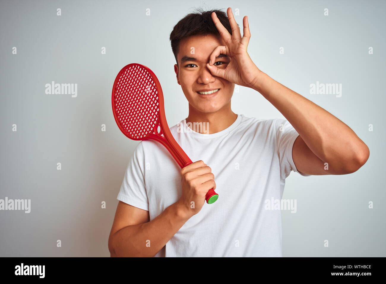 Asian chinese sportsman holding tennis racket standing over isolated ...