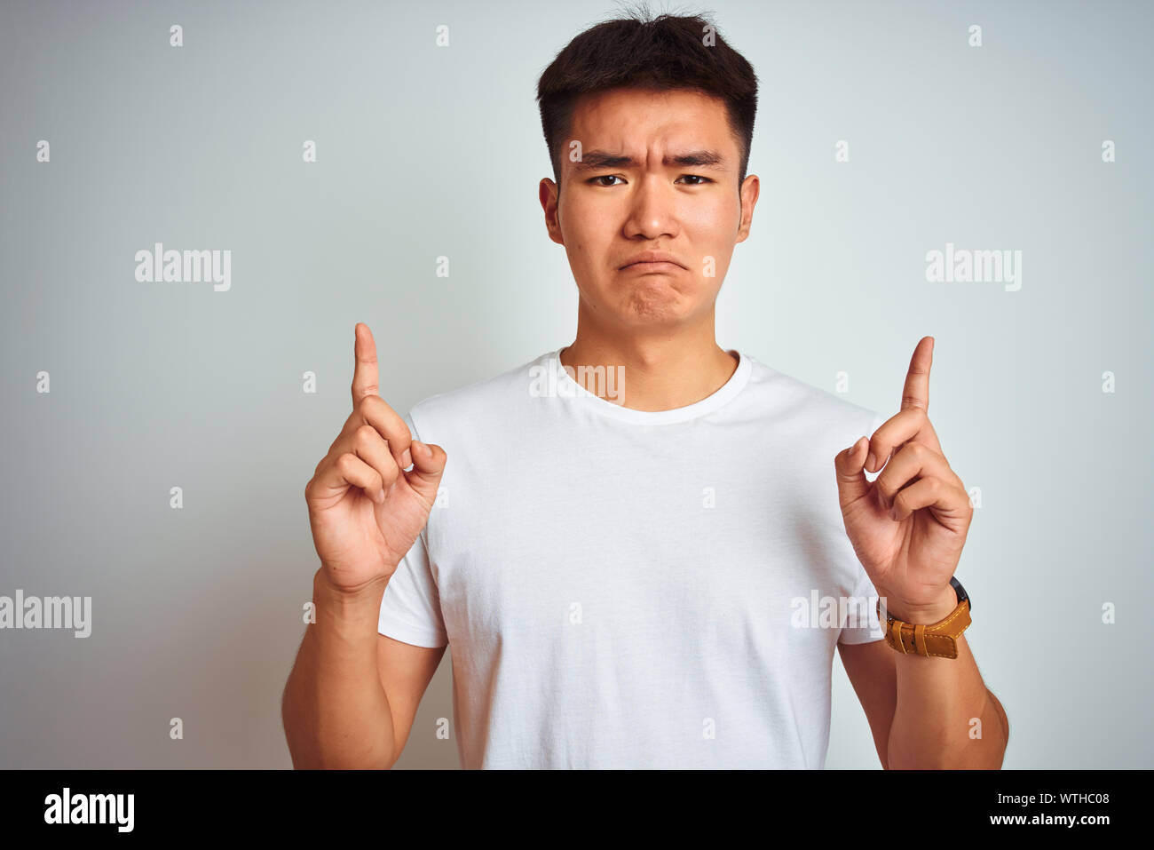 Young Asian Chinese Man Wearing T Shirt Standing Over Isolated White