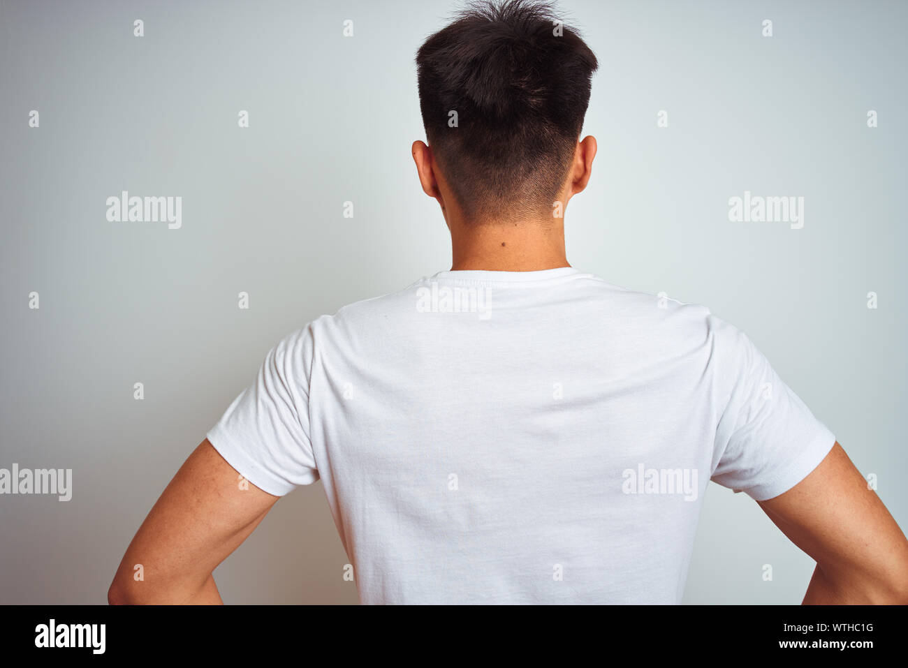 Young Asian Chinese Man Wearing T Shirt Standing Over Isolated White