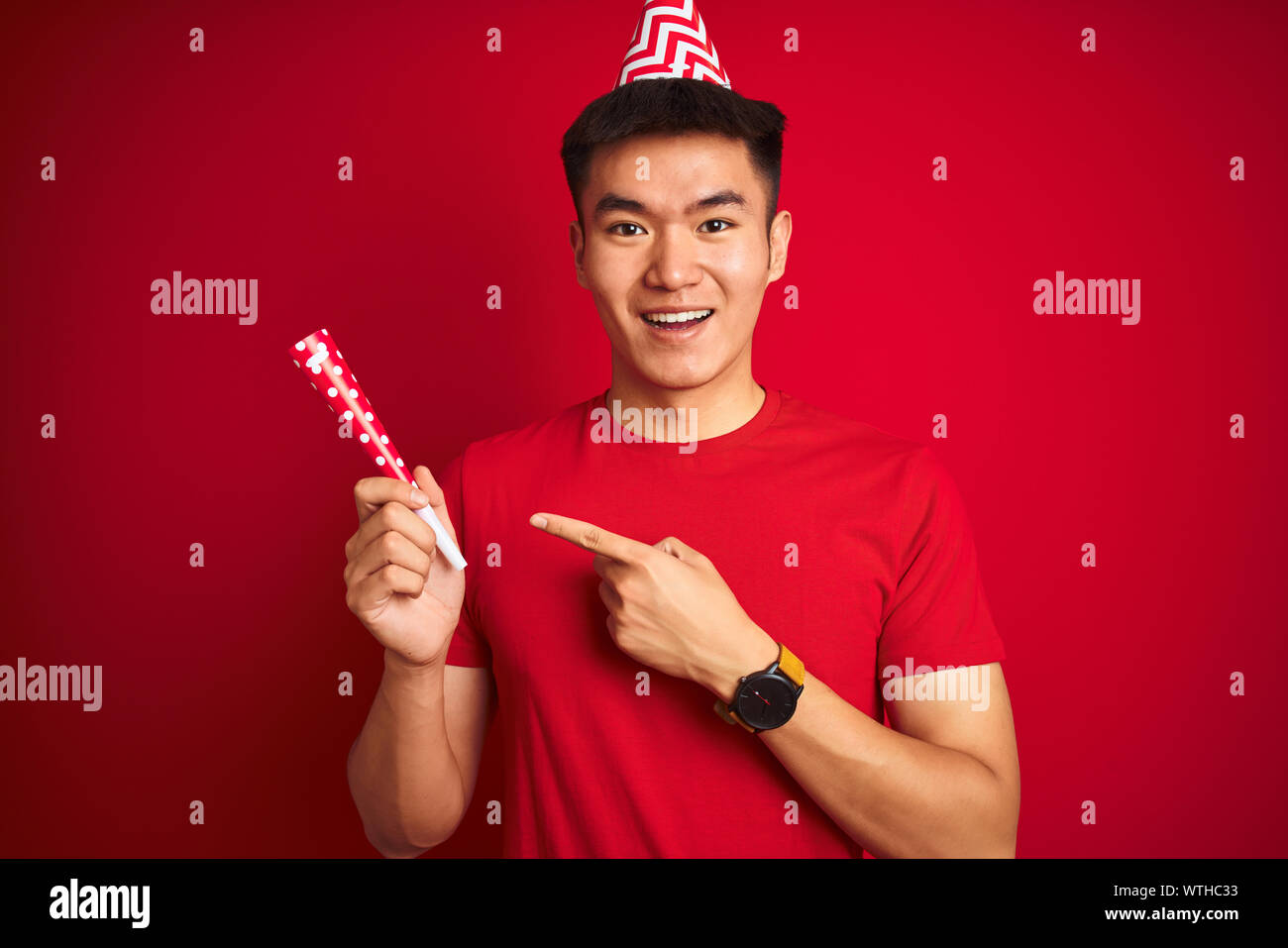 Asian chinese man on birthday celebration wearing funny hat over ...