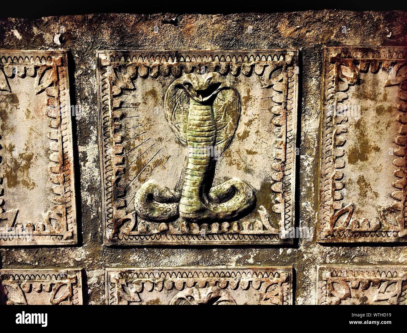 Stone Wall With Cobra Bas Relief Stock Photo - Alamy