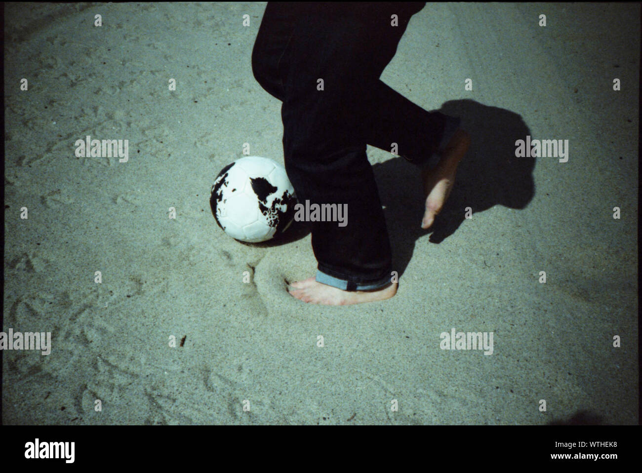 Low Section Of Man Practicing Football Stock Photo - Alamy