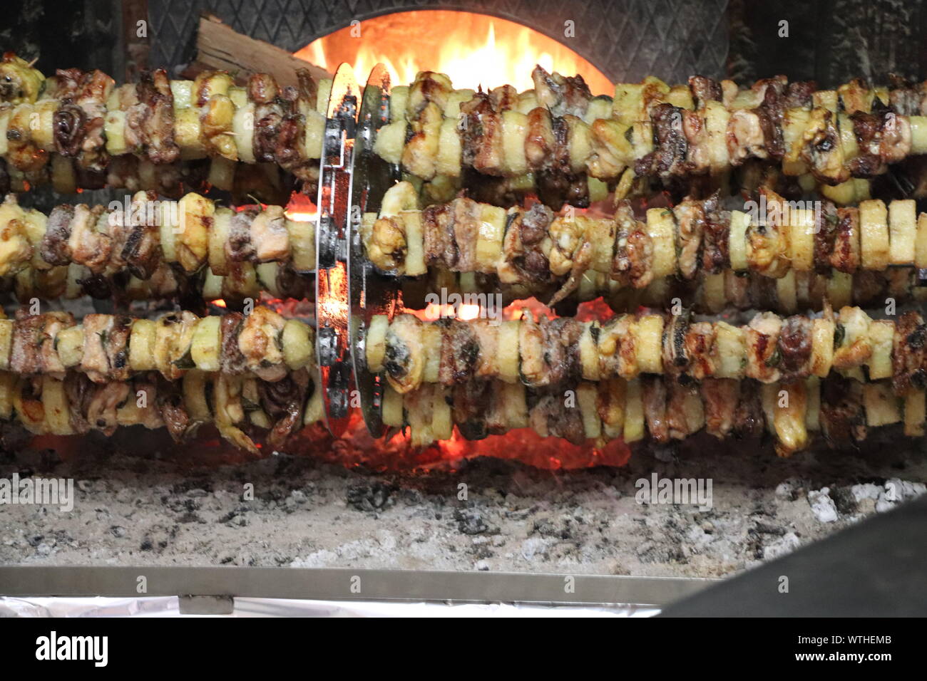 Roasted meat on spit grilled over fire Stock Photo - Alamy