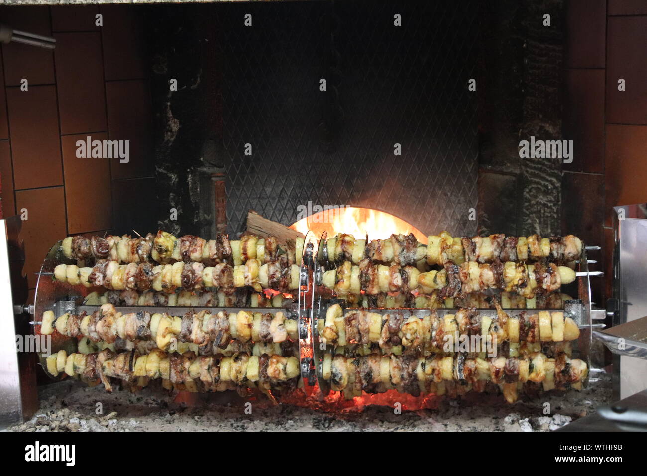 Roasted meat on spit grilled over fire Stock Photo - Alamy