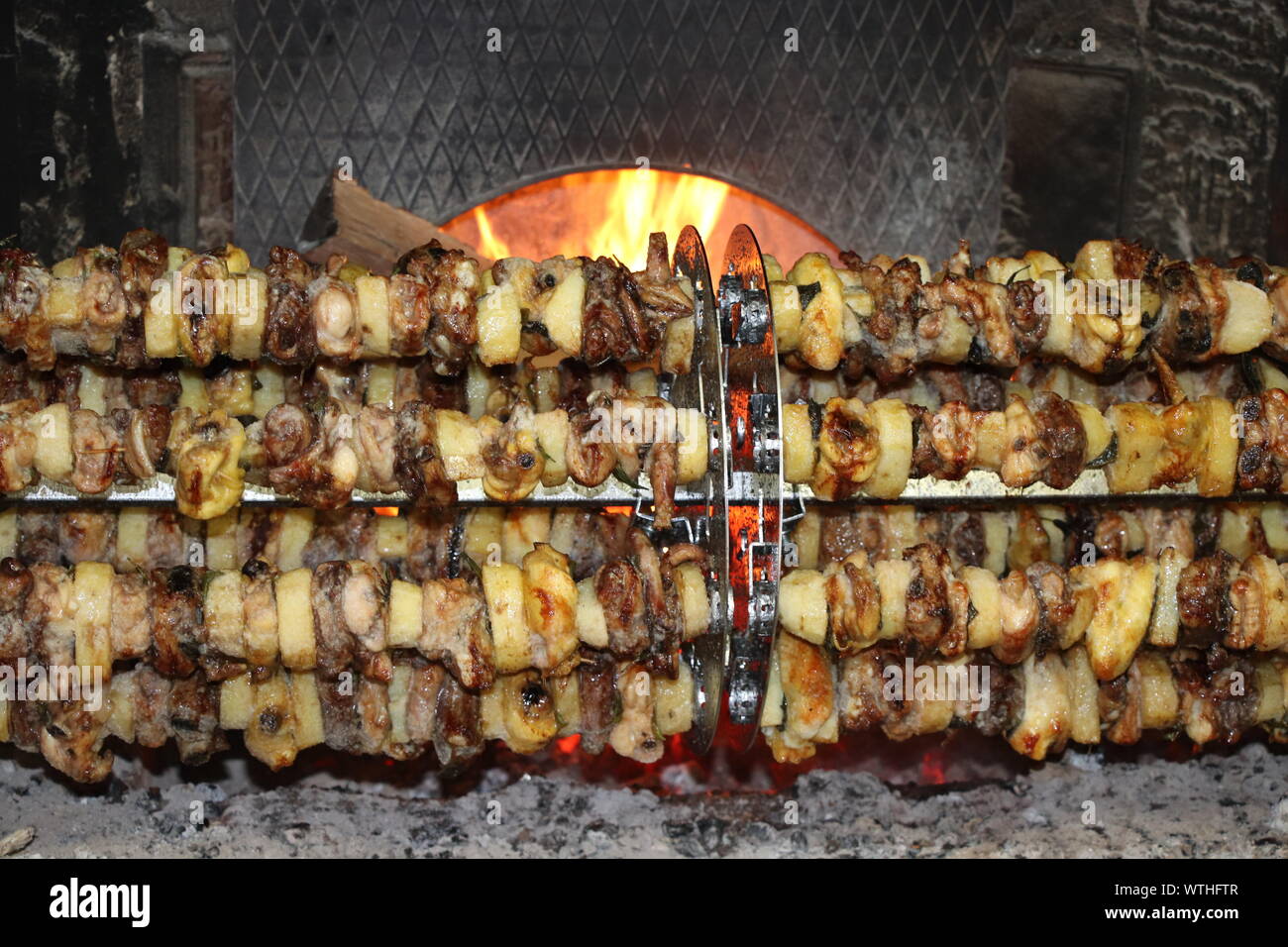 Roasted meat on spit grilled over fire Stock Photo - Alamy
