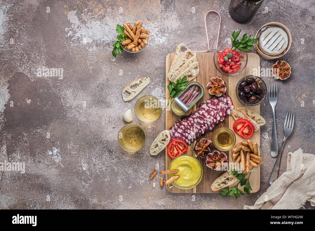 Typical spanish tapas concept. salami slices, cheese, bowls with olives ...