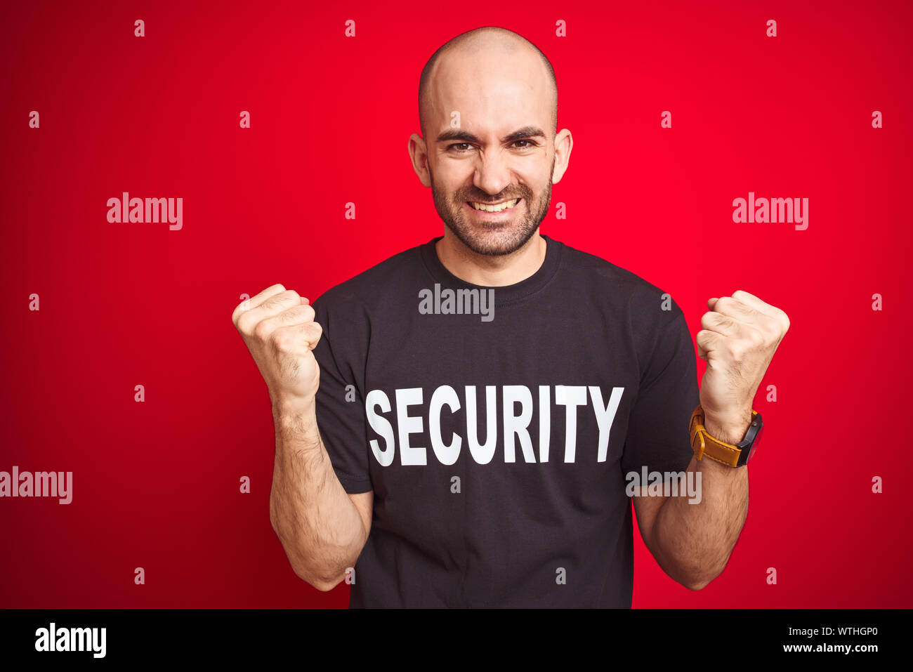 Young safeguard man wearing security uniform over red isolated ...