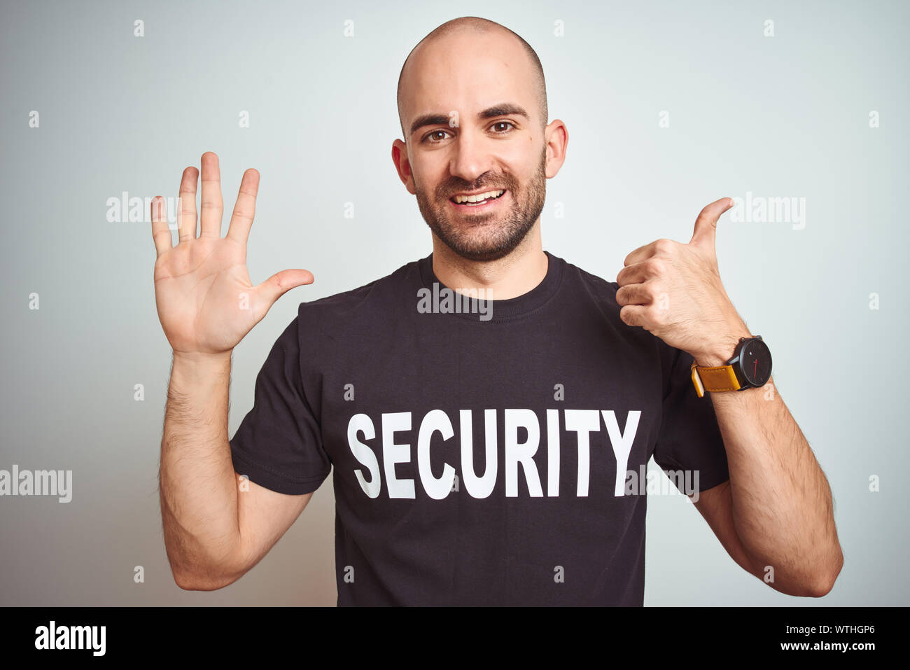Young safeguard man wearing security uniform over isolated background ...