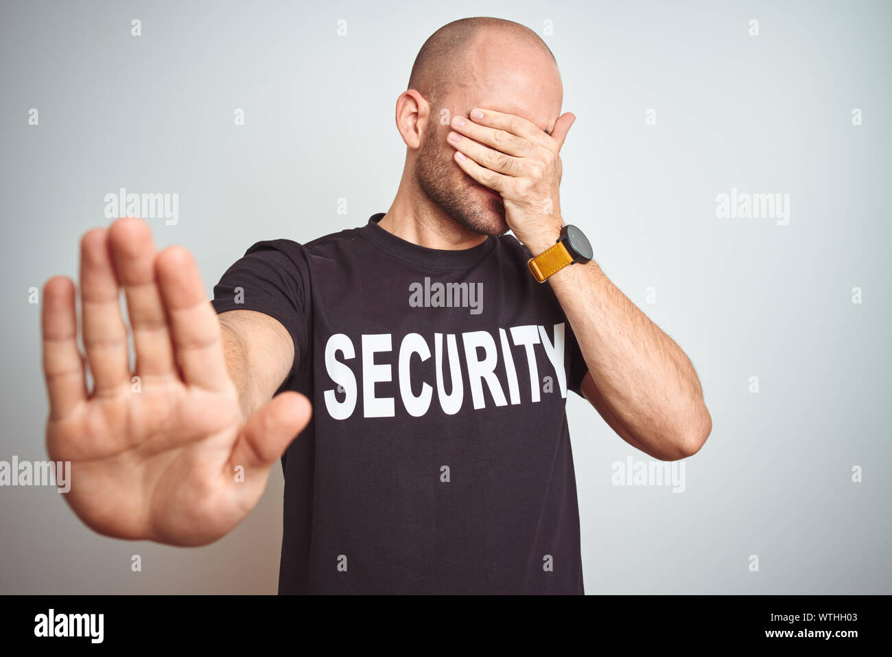 Young safeguard man wearing security uniform over isolated background ...