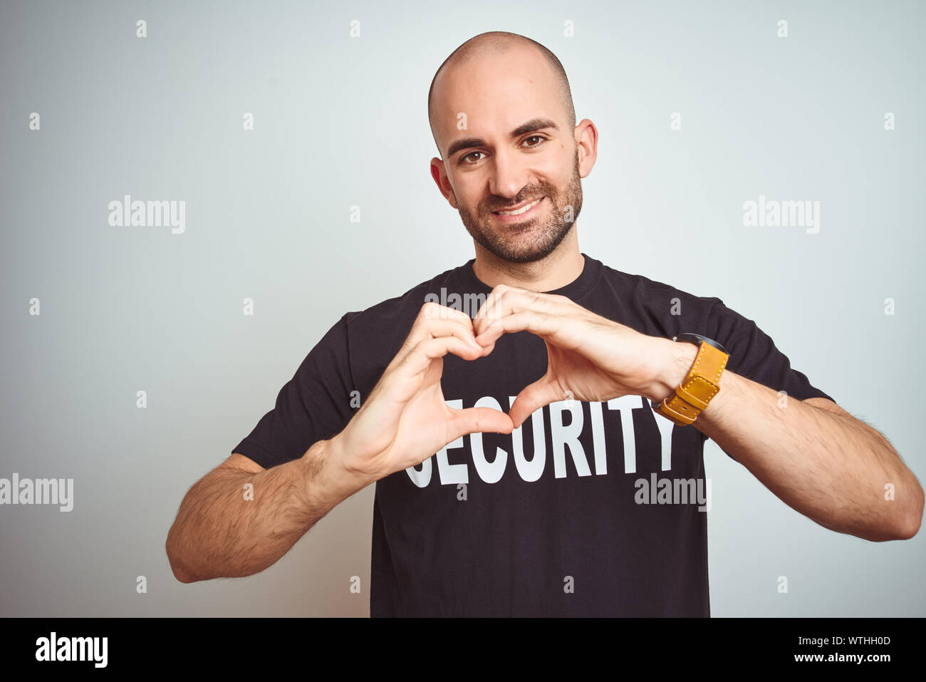 Young safeguard man wearing security uniform over isolated background ...