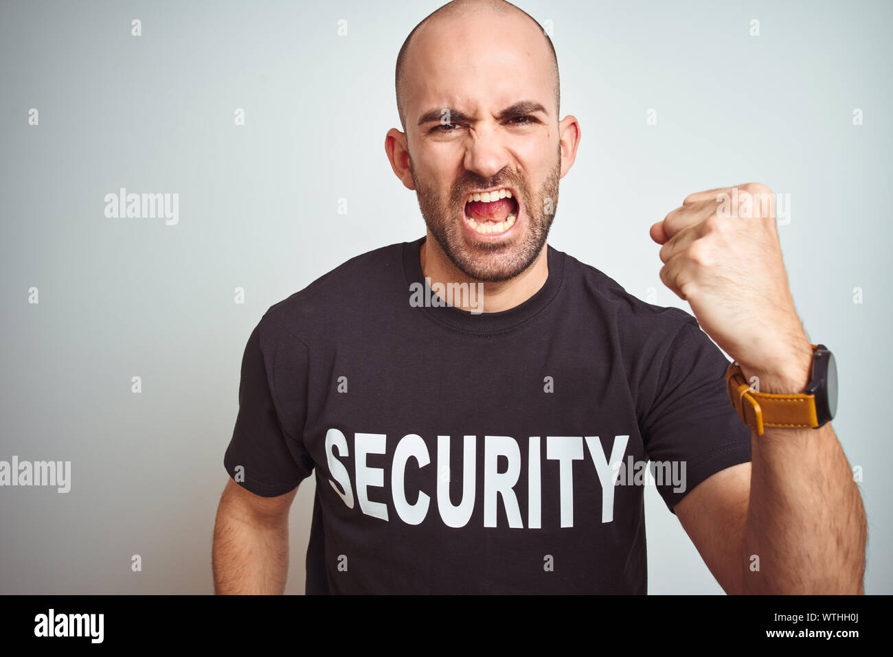 Young safeguard man wearing security uniform over isolated background ...