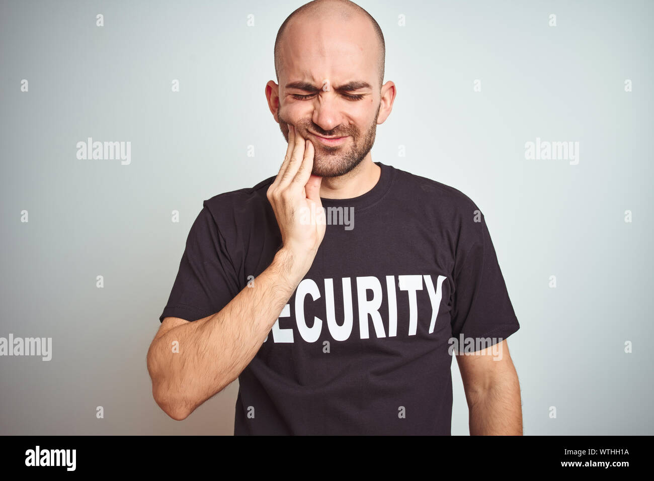 Young safeguard man wearing security uniform over isolated background ...