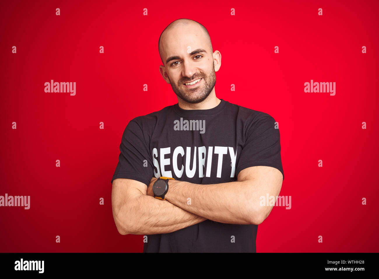 Young safeguard man wearing security uniform over red isolated ...
