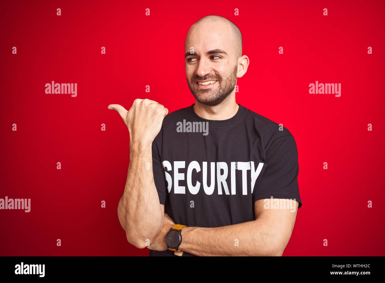 Young safeguard man wearing security uniform over red isolated ...