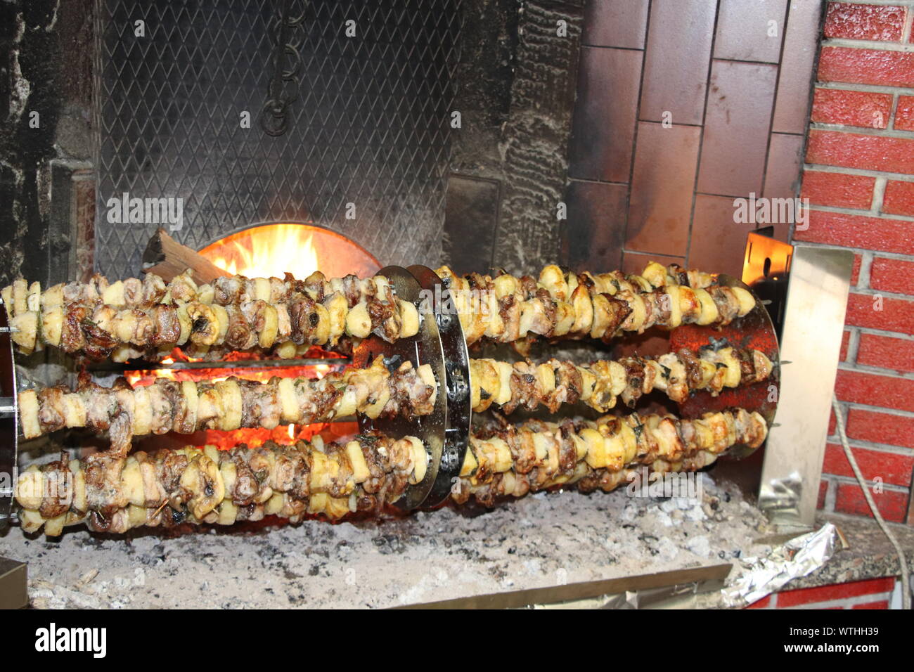 Roasted meat on spit grilled over fire Stock Photo - Alamy