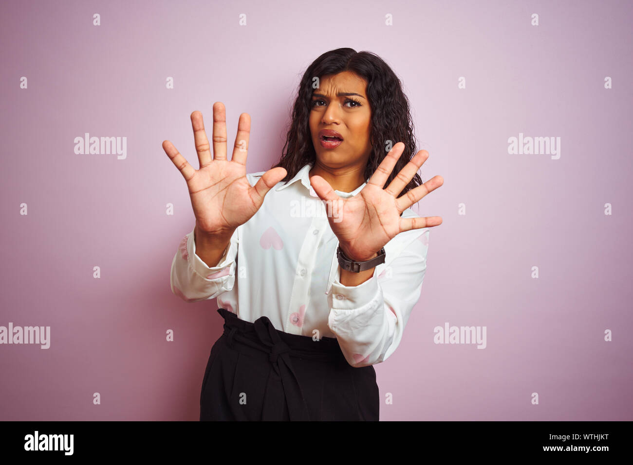 Transsexual transgender businesswoman standing over isolated pink ...