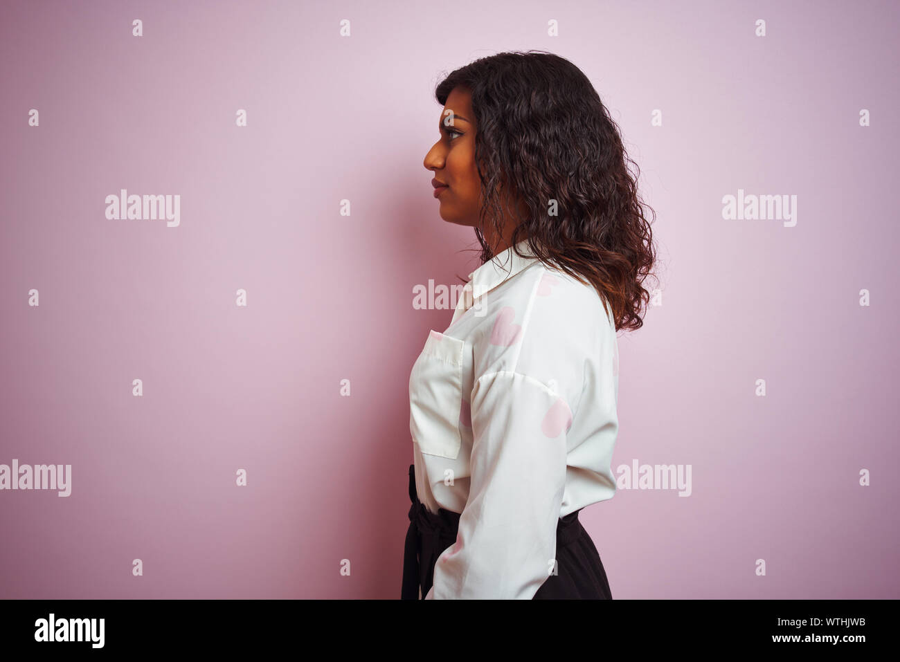 Transsexual transgender businesswoman standing over isolated pink ...