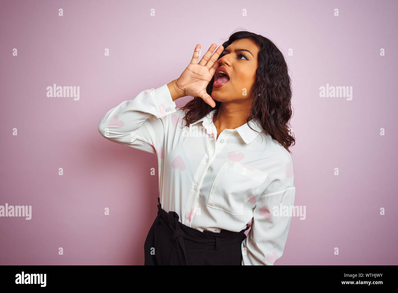 Transsexual transgender businesswoman standing over isolated pink ...
