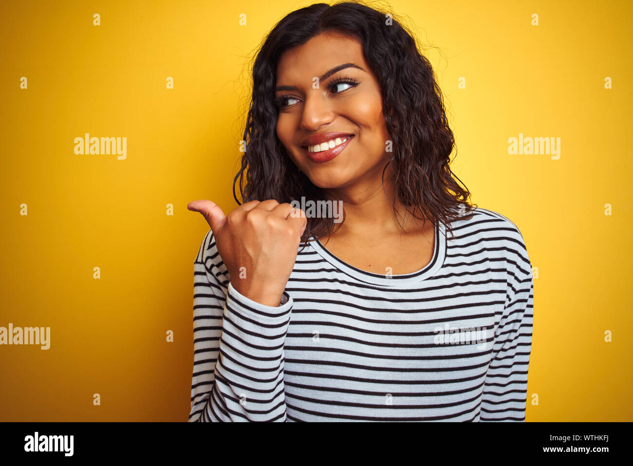 Transsexual transgender woman wearing striped t-shirt over isolated ...
