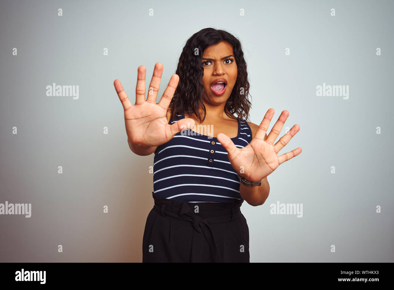 Transsexual transgender woman wearing striped t-shirt over isolated ...