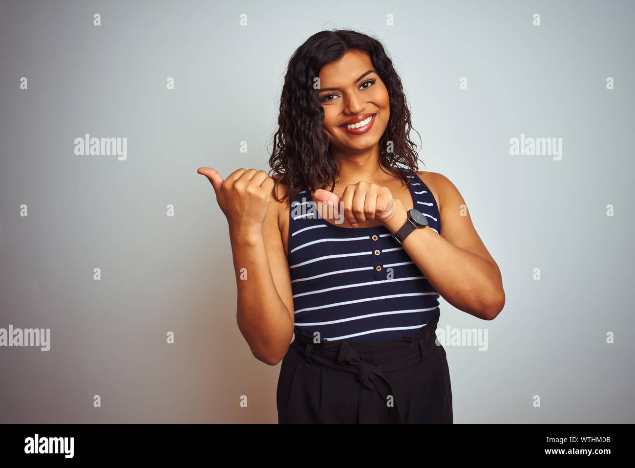 Transsexual transgender woman wearing striped t-shirt over isolated ...